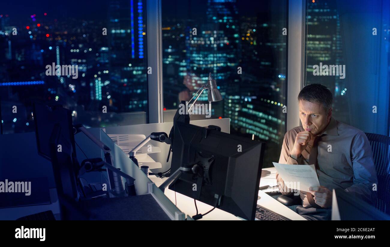 Businessman working late at computer in office Stock Photo - Alamy