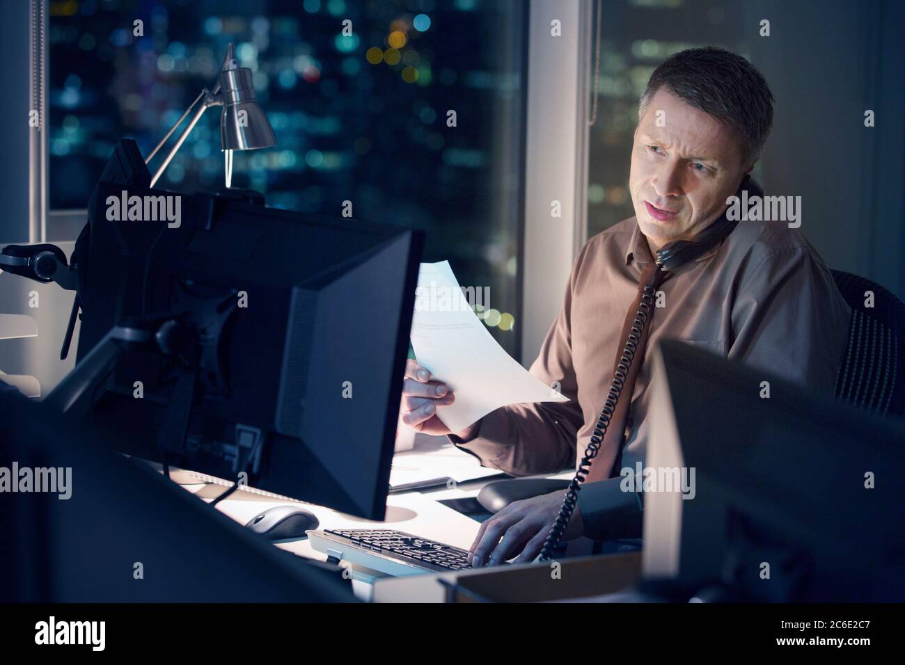 Businessman working late at computer in office Stock Photo - Alamy