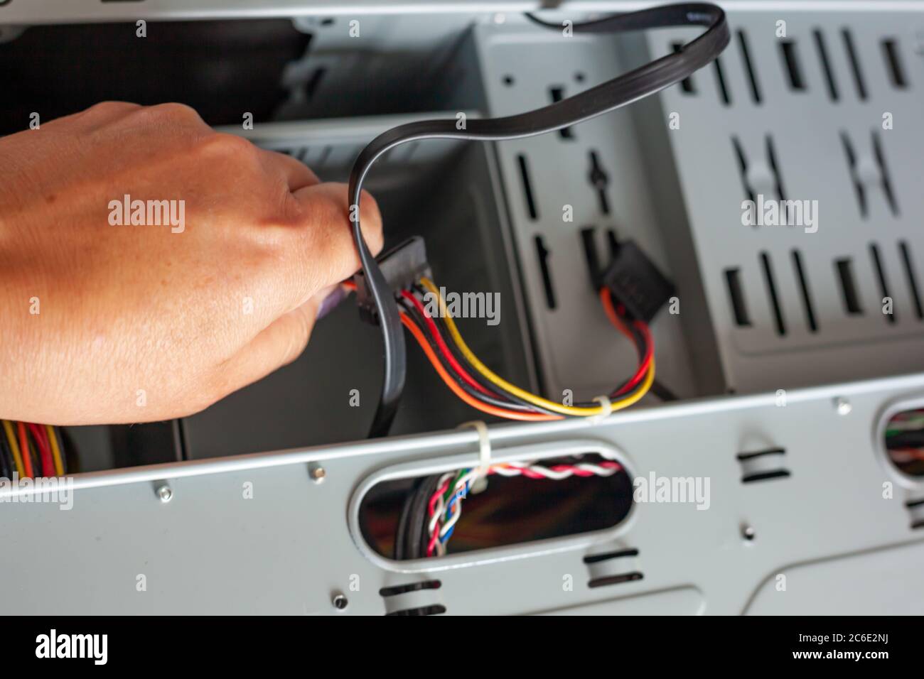 Inside tech - high-resolution close-up of a hand holding computer cable ...