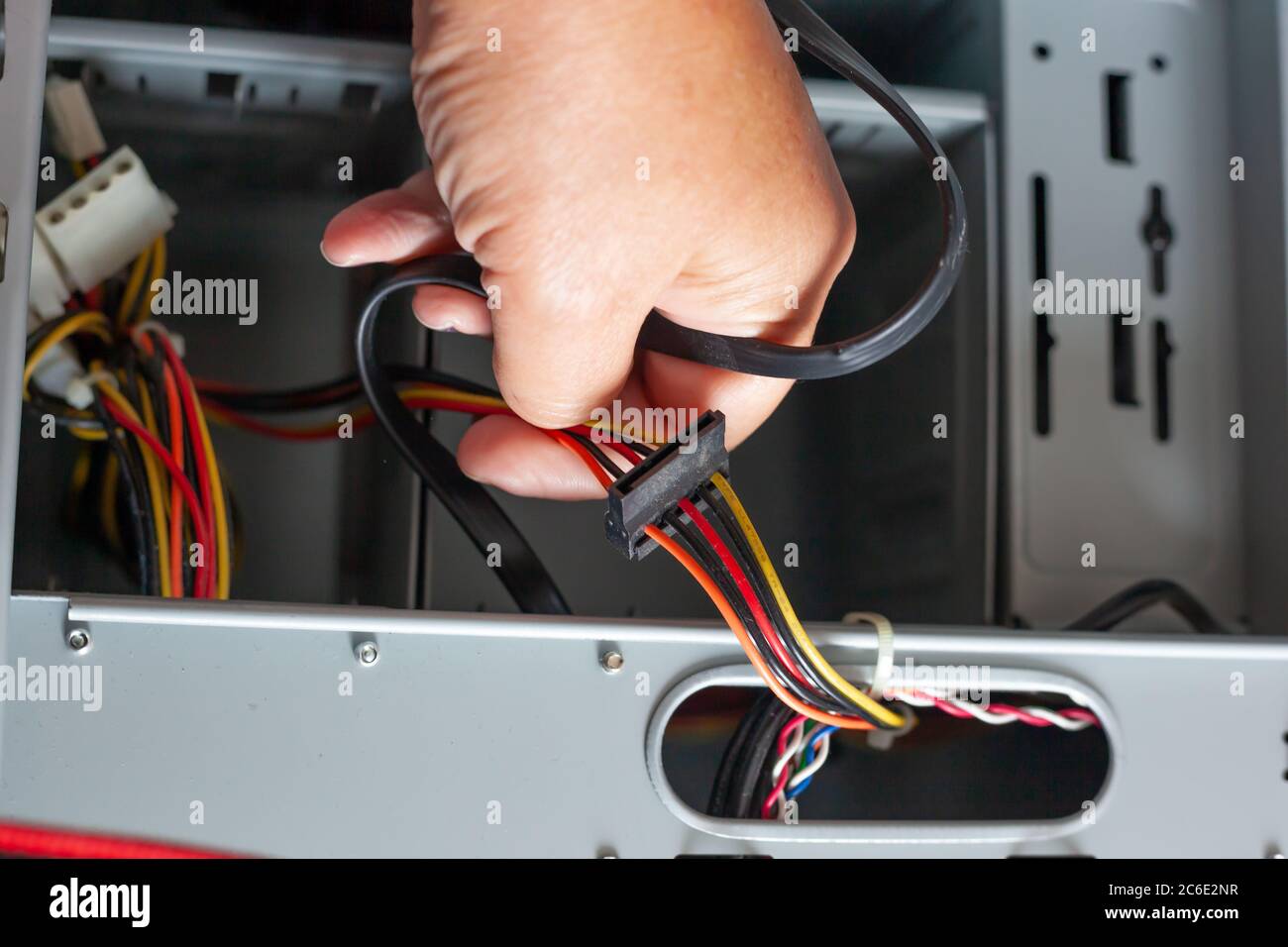 Inside tech - high-resolution close-up of a hand holding computer cable ...