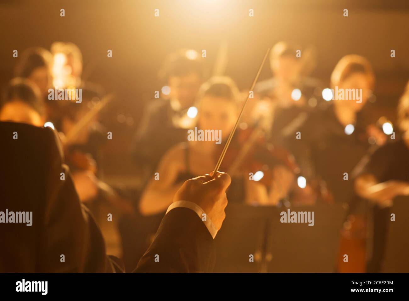 Conductor leading orchestra Stock Photo - Alamy