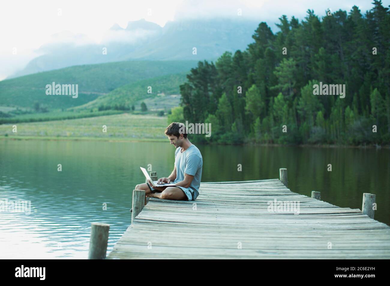 Man sitting on dock hi-res stock photography and images - Alamy