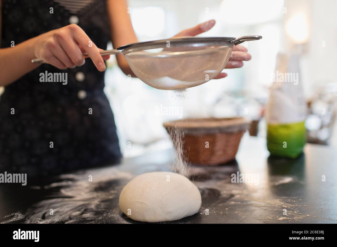 Close up woman sifting flour of bread dough on kitchen counter Stock ...