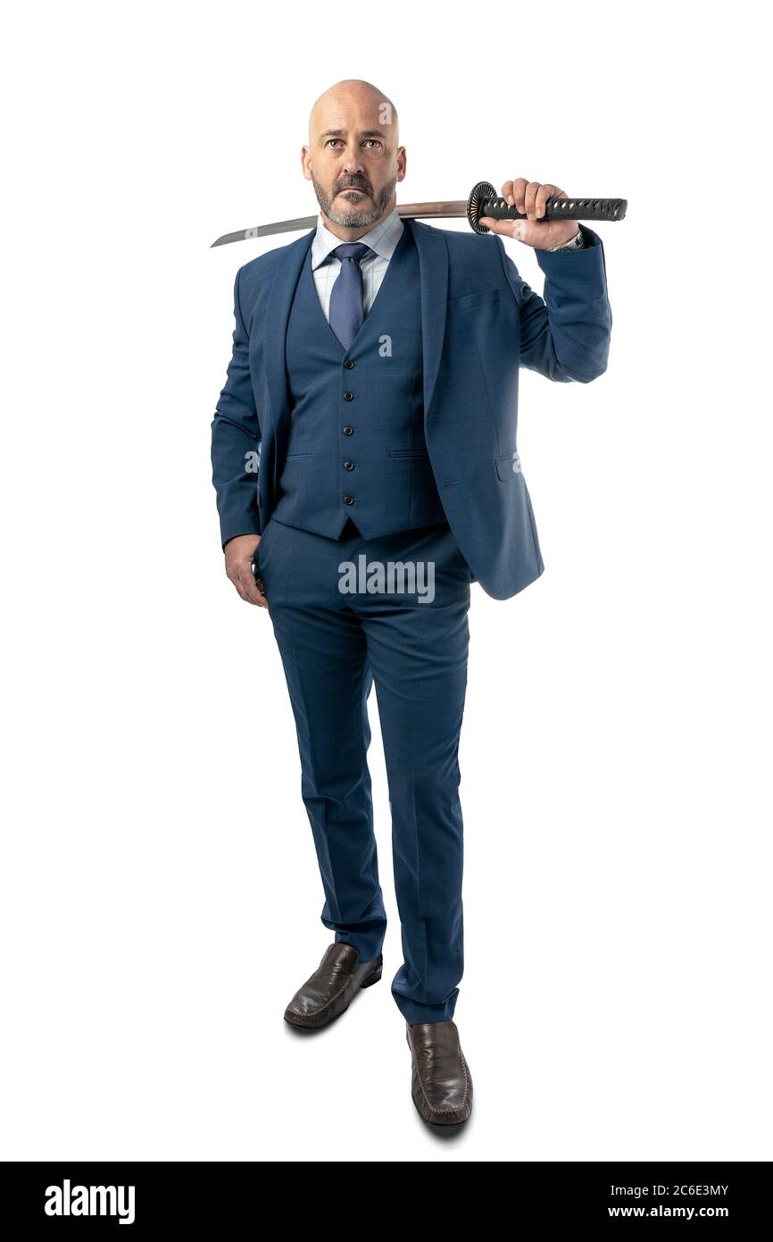 A man in a suit relaxing holding a samurai sword on his shoulder Stock ...
