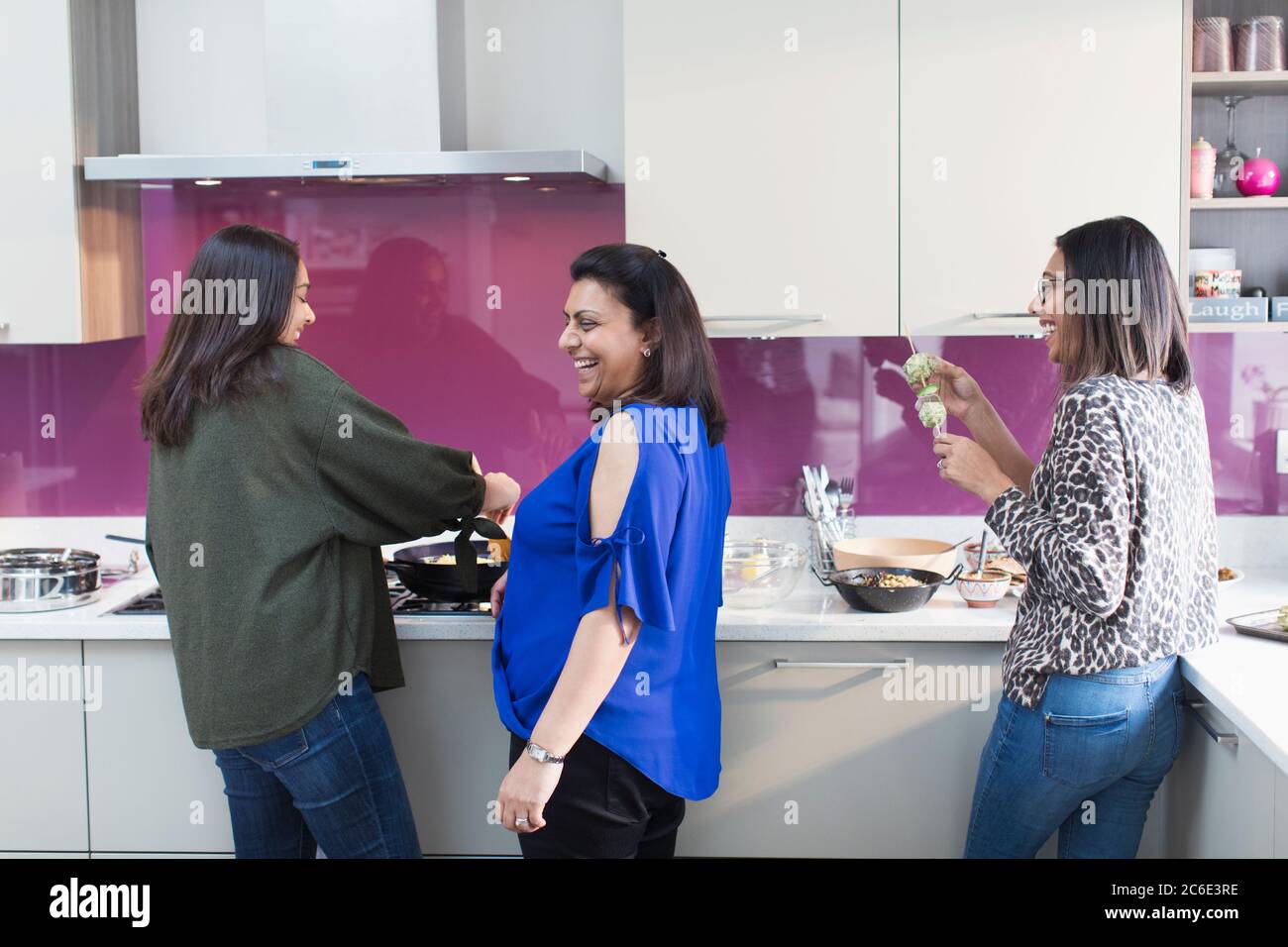 Happy Indian women cooking food in kitchen Stock Photo - Alamy