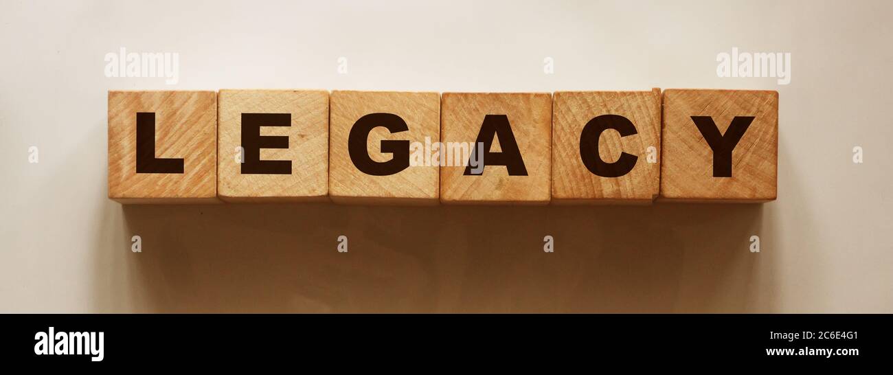 Word LEGACY on Wooden cubes on light background with shadow. Last will ...