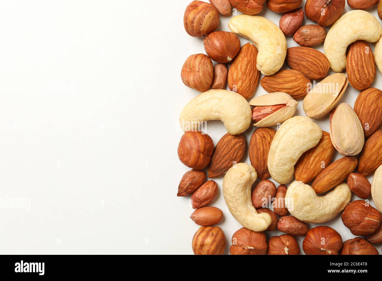 Different tasty nuts on white background. Vitamin food Stock Photo - Alamy