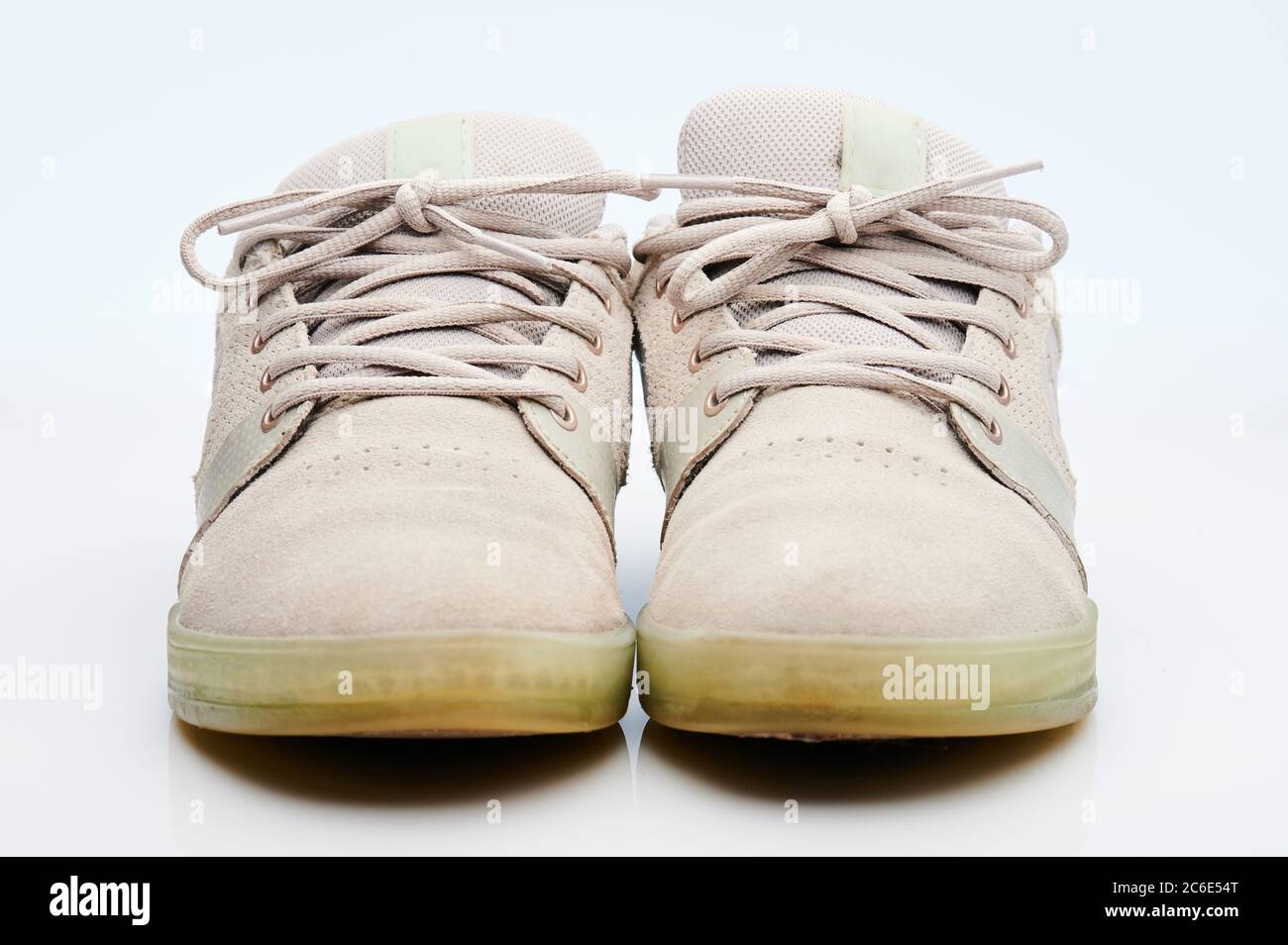 Front view of grey pair shoes isolated on white background Stock Photo ...