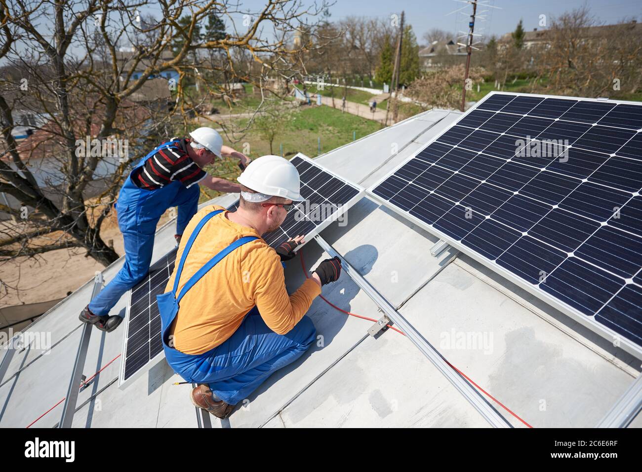 Male engineers installing solar photovoltaic panel system. Electricians ...