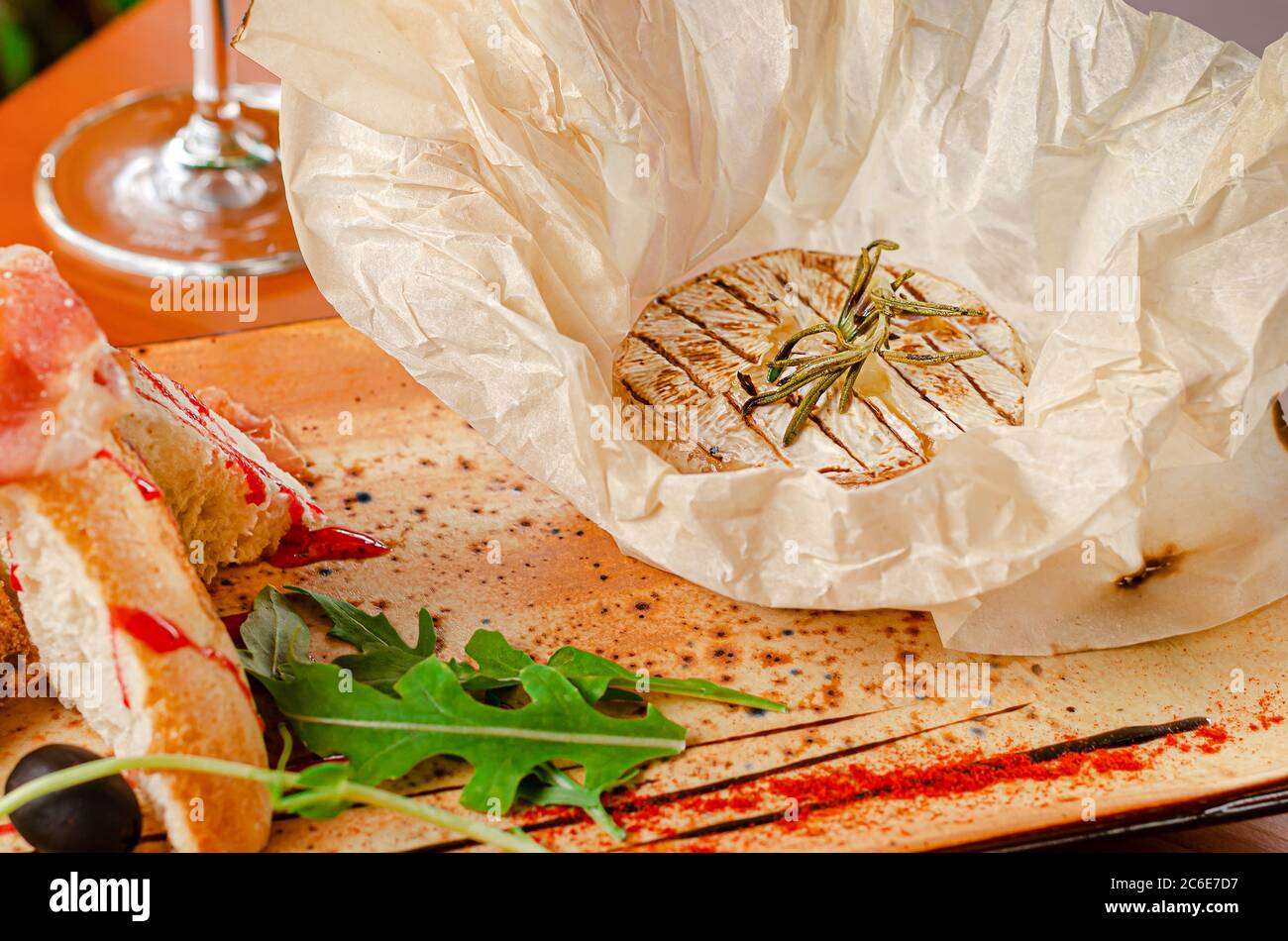 Grilled Camembert cheese with rosemary. French cuisine, restaurant ...