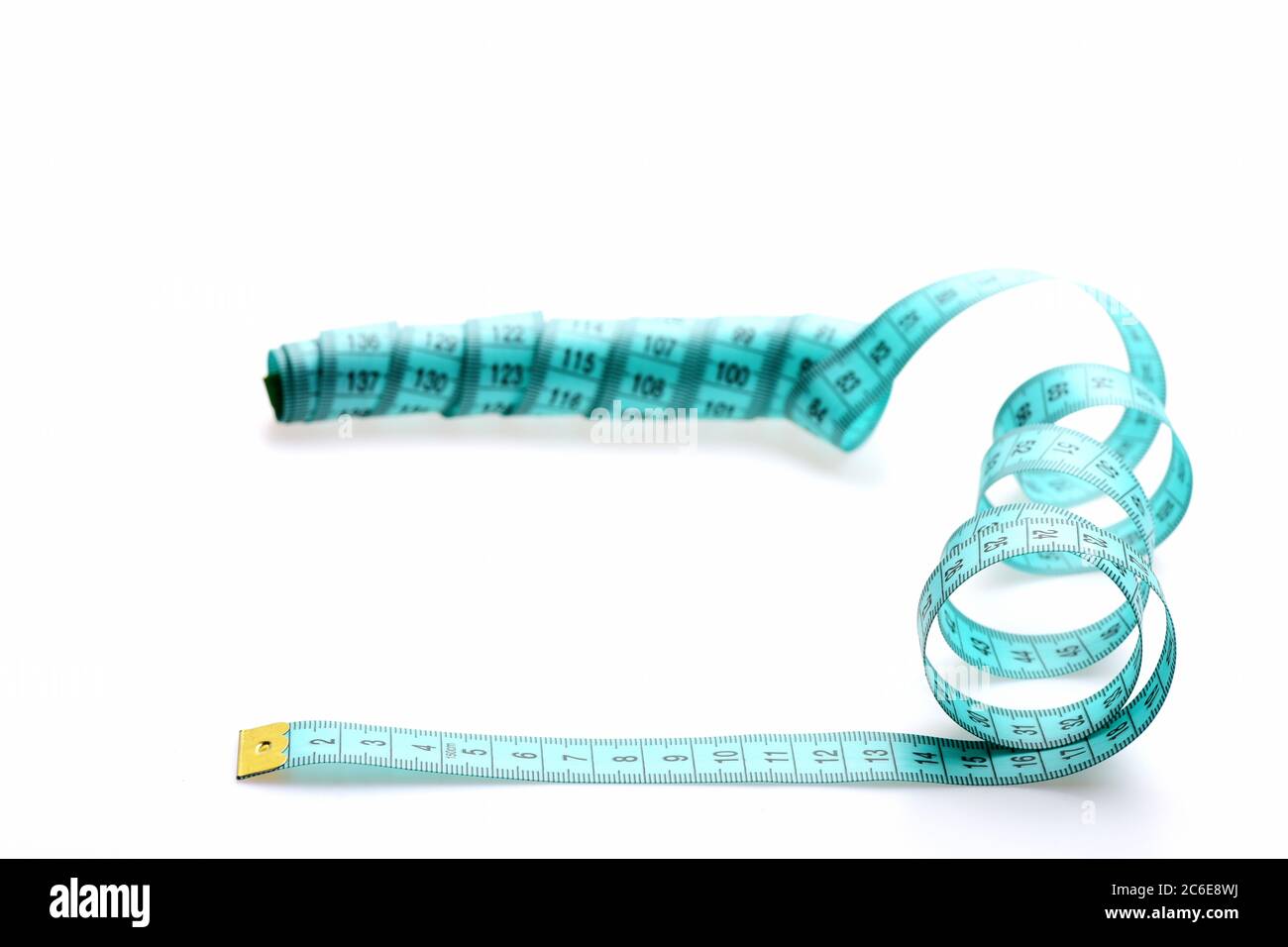 Roll of cyan flexible ruler untwisted curly, isolated on white ...