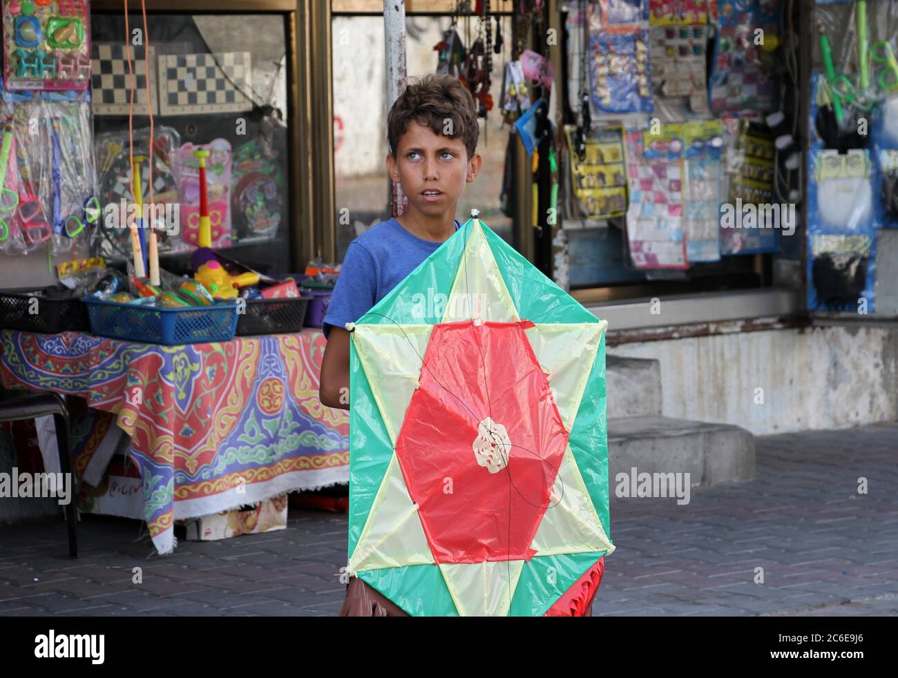 Gaza. 6th July, 2020. A Palestinian child holds a kite to fly it in ...