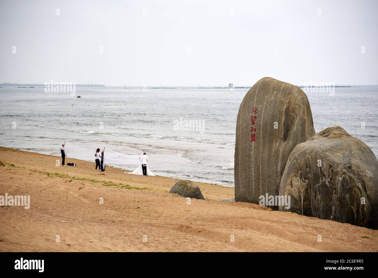 Rizhao. 9th July, 2020. A couple pose for wedding photos on a beach in ...