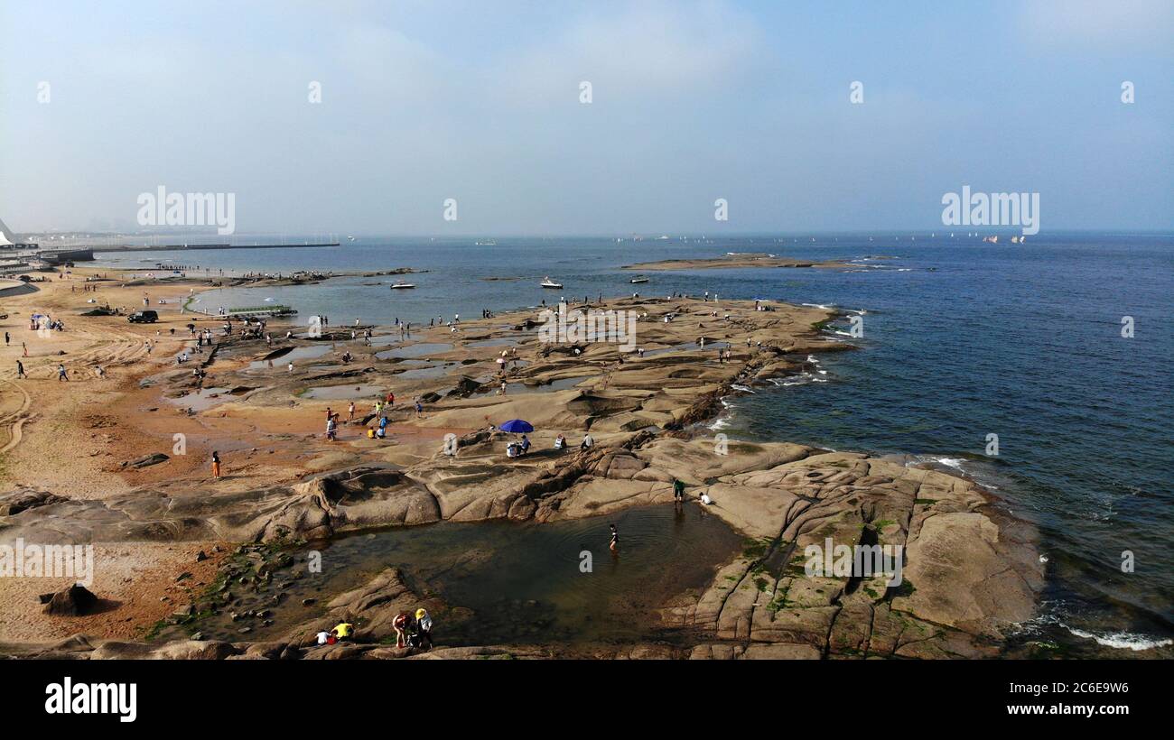 Rizhao. 8th July, 2020. Aerial photo shows people enjoying their time ...