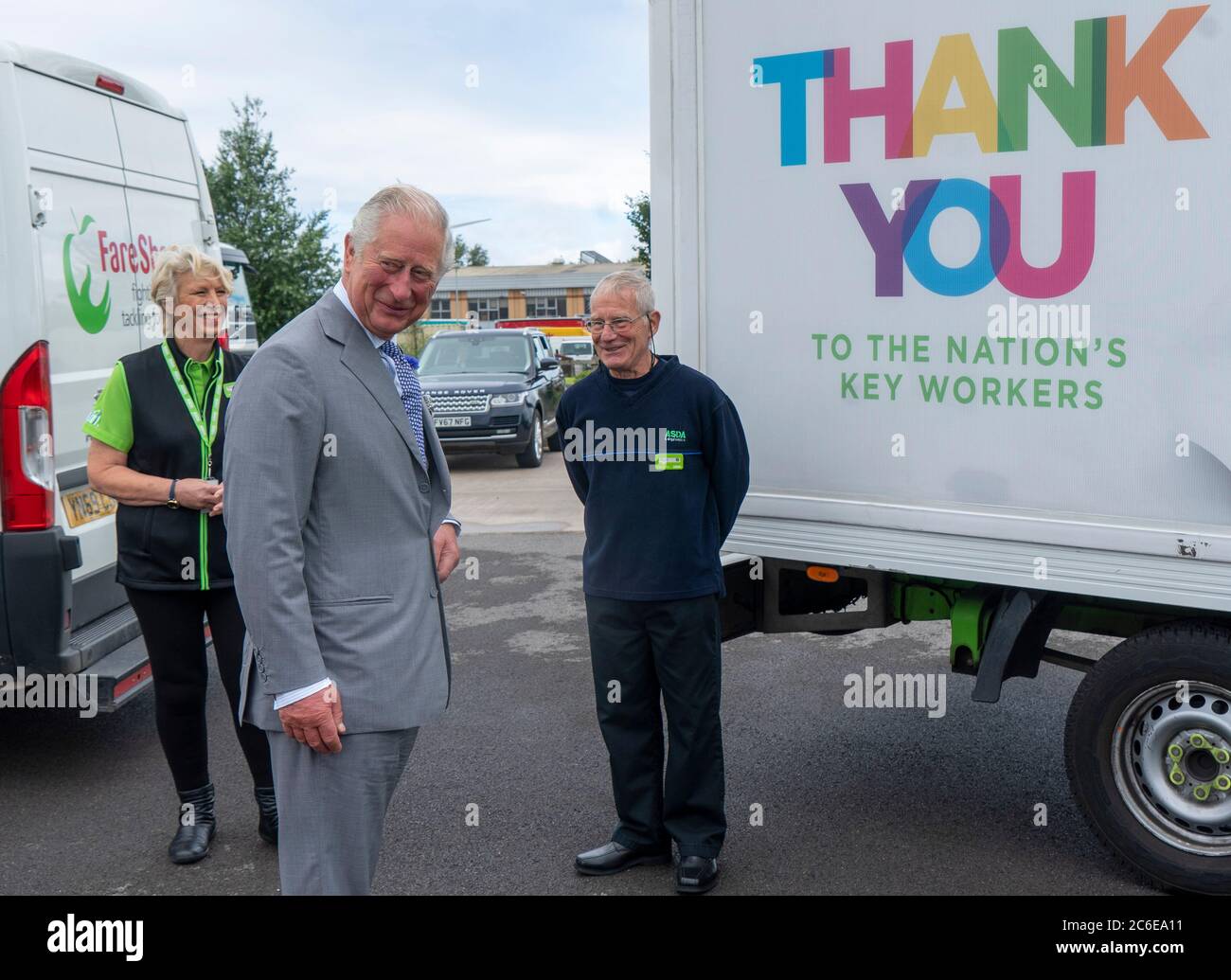 The Prince of Wales stands with Asda staff members during his visit to ...