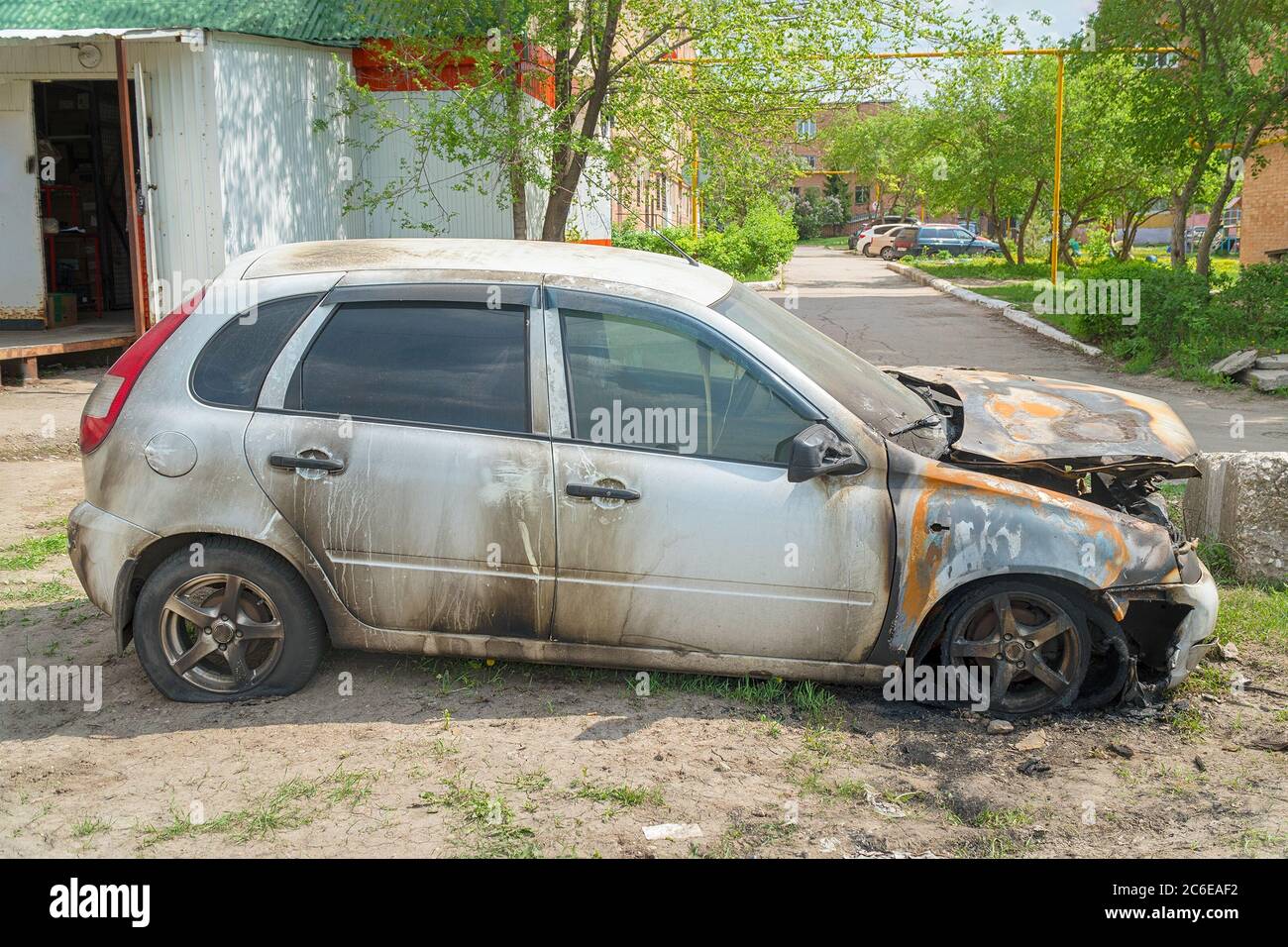 Burnt car on the street. Side view Stock Photo - Alamy
