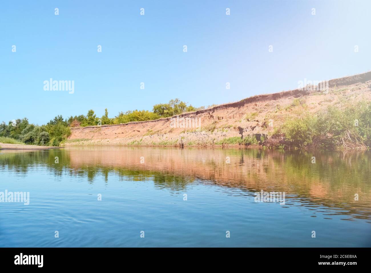 Summer river landscape with a steep Bank and blue sky Stock Photo - Alamy