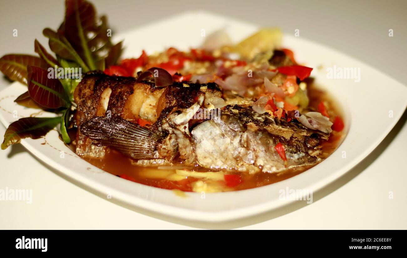 Pecak gabus or snakehead fish. Spicy and delicious. Traditional dish ...