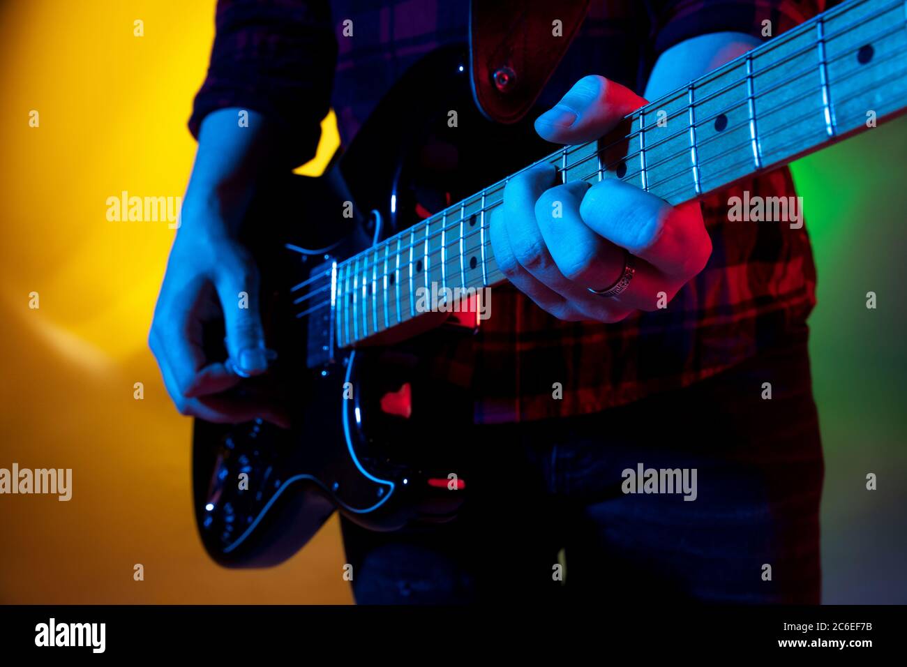 Close up young inspired and expressive musician, guitarist performing ...