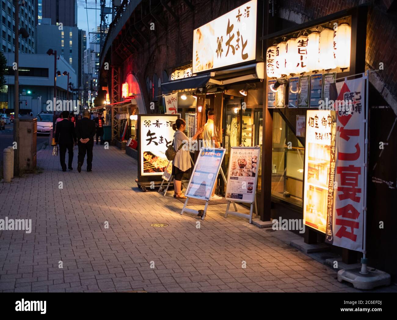 People walking in Yurakucho street back alley, a popular after office ...