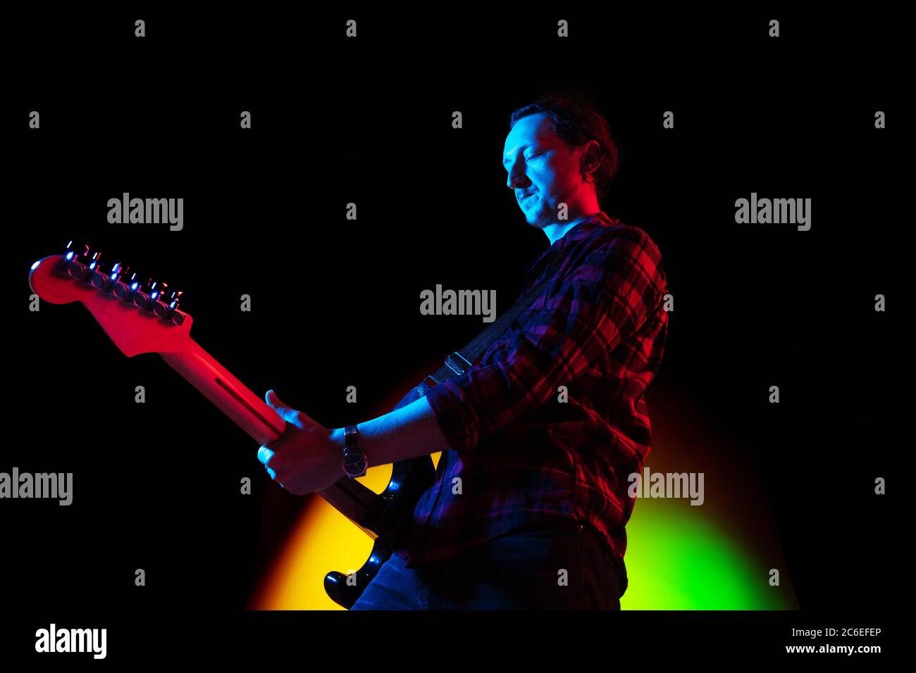 Dark mood. Young inspired and expressive musician, guitarist performing ...