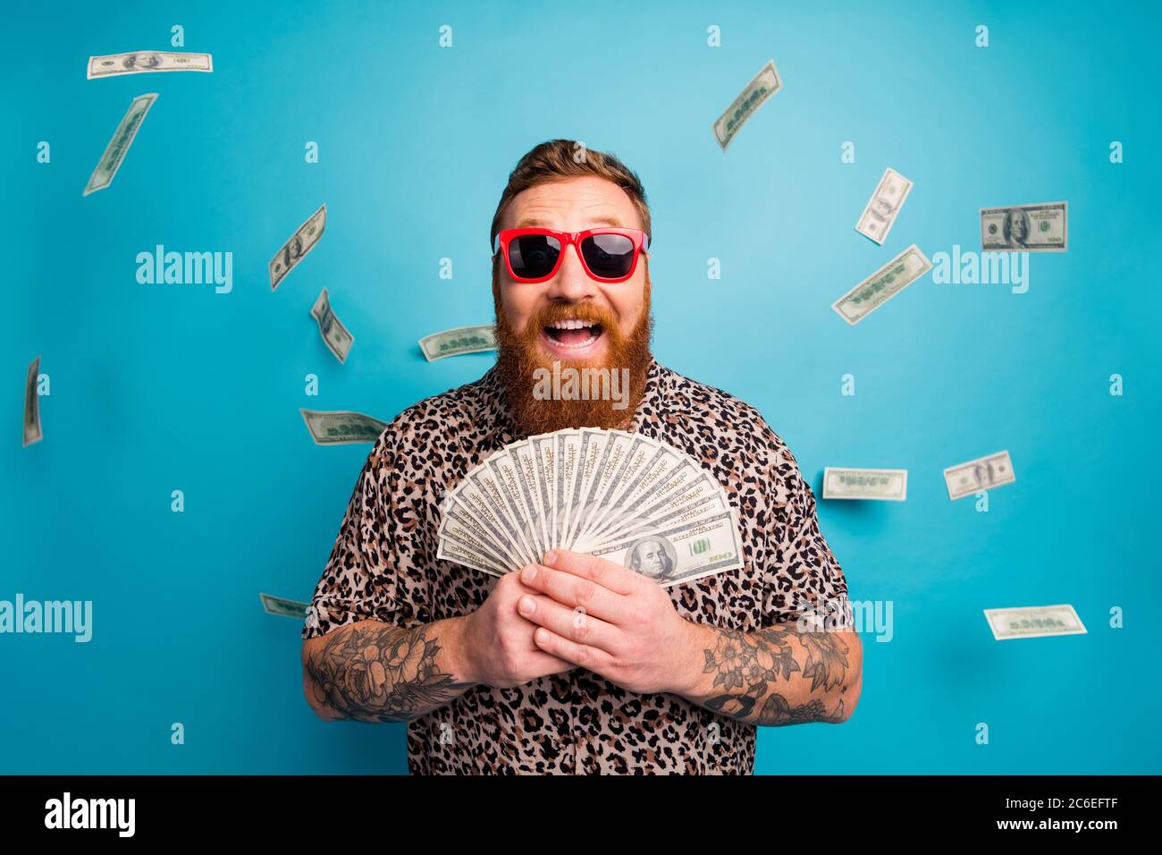 Photo of excited crazy macho guy hold fan american bucks excited mood ...