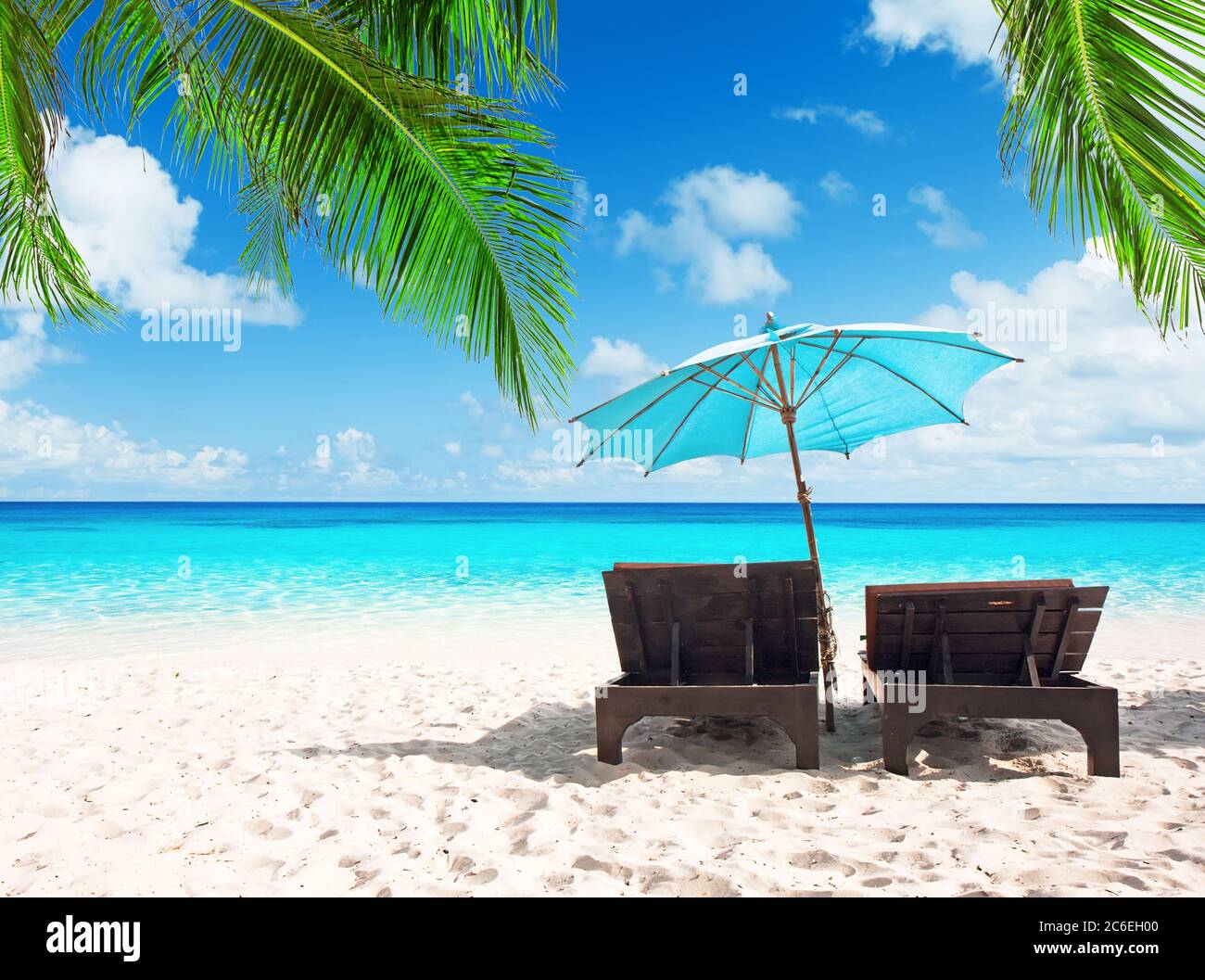 Beach chairs with umbrella and beautiful sand beach Stock Photo - Alamy