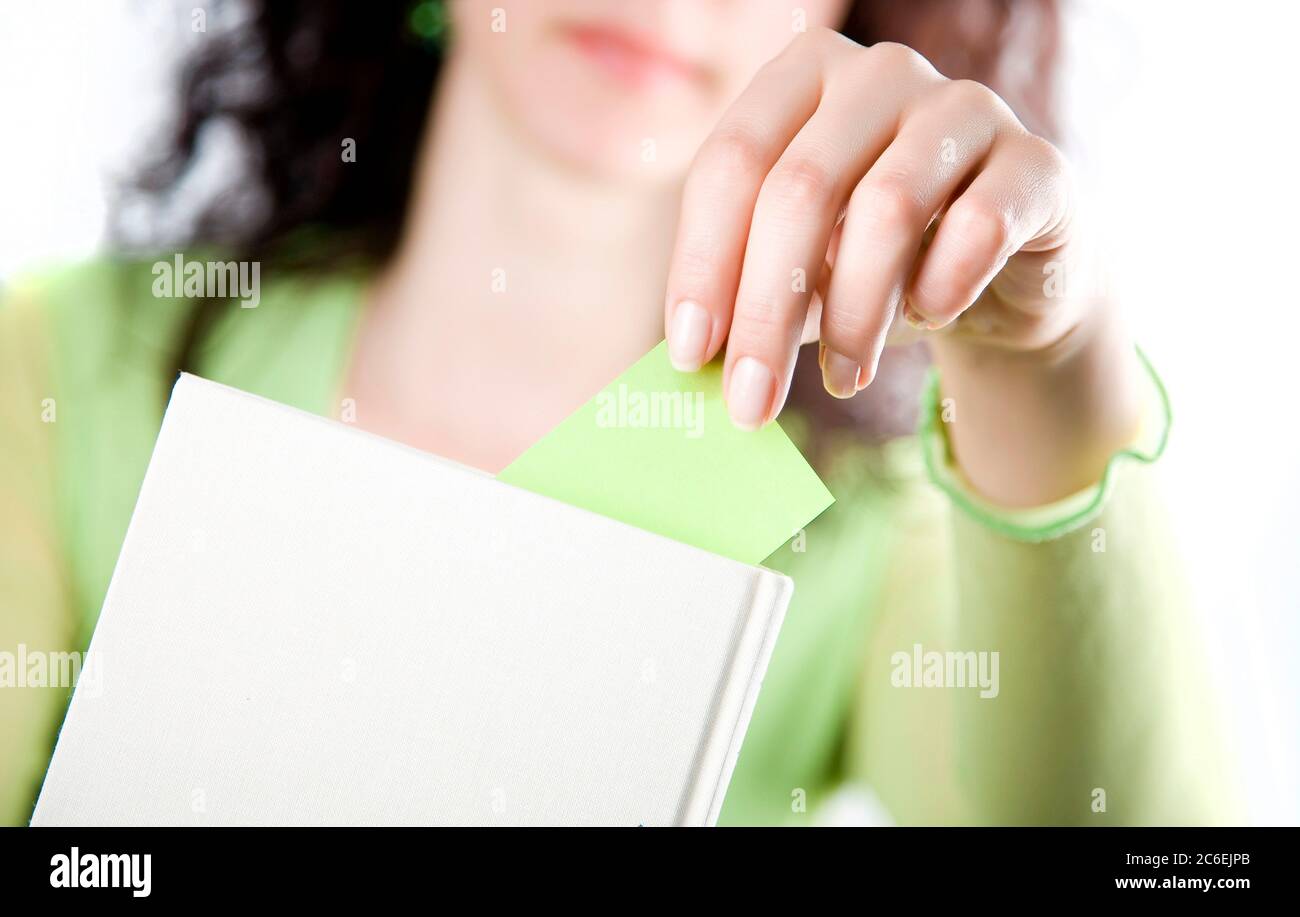Female hand holding bookmark in book Stock Photo - Alamy