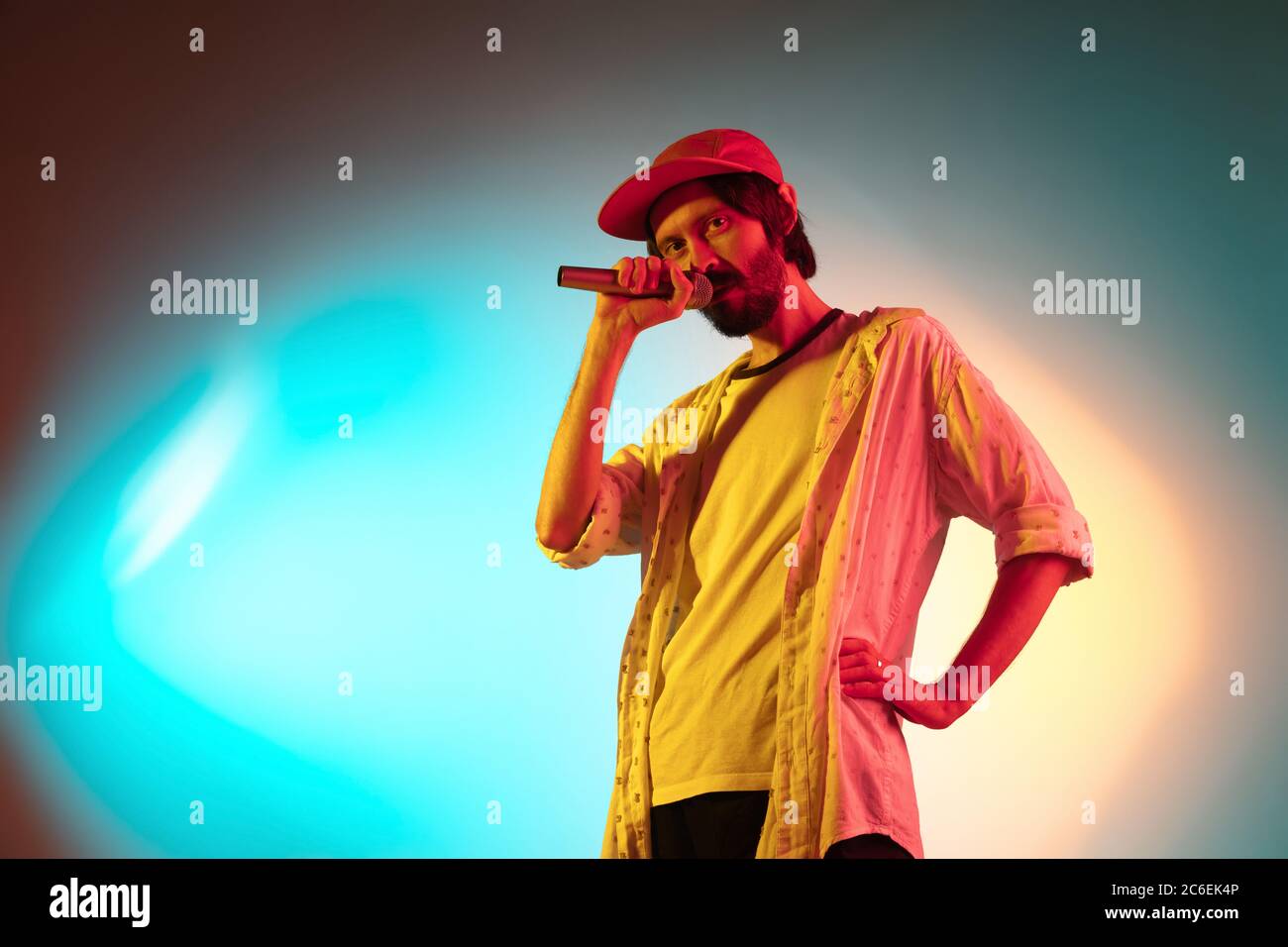 In fire. Young inspired and expressive musician, singer performing on ...