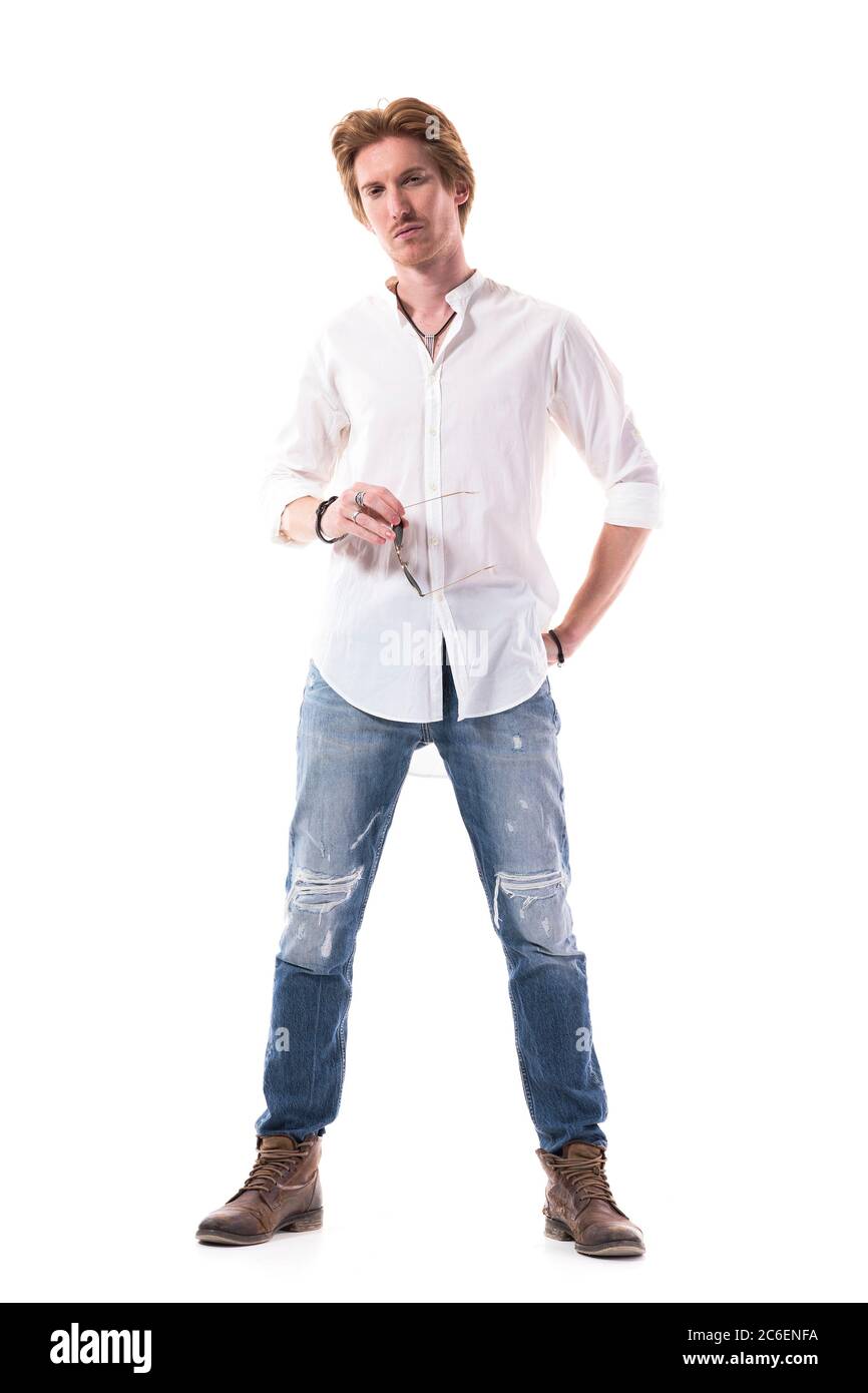 Young stylish man fashion model with evaluating frowning look at camera ...