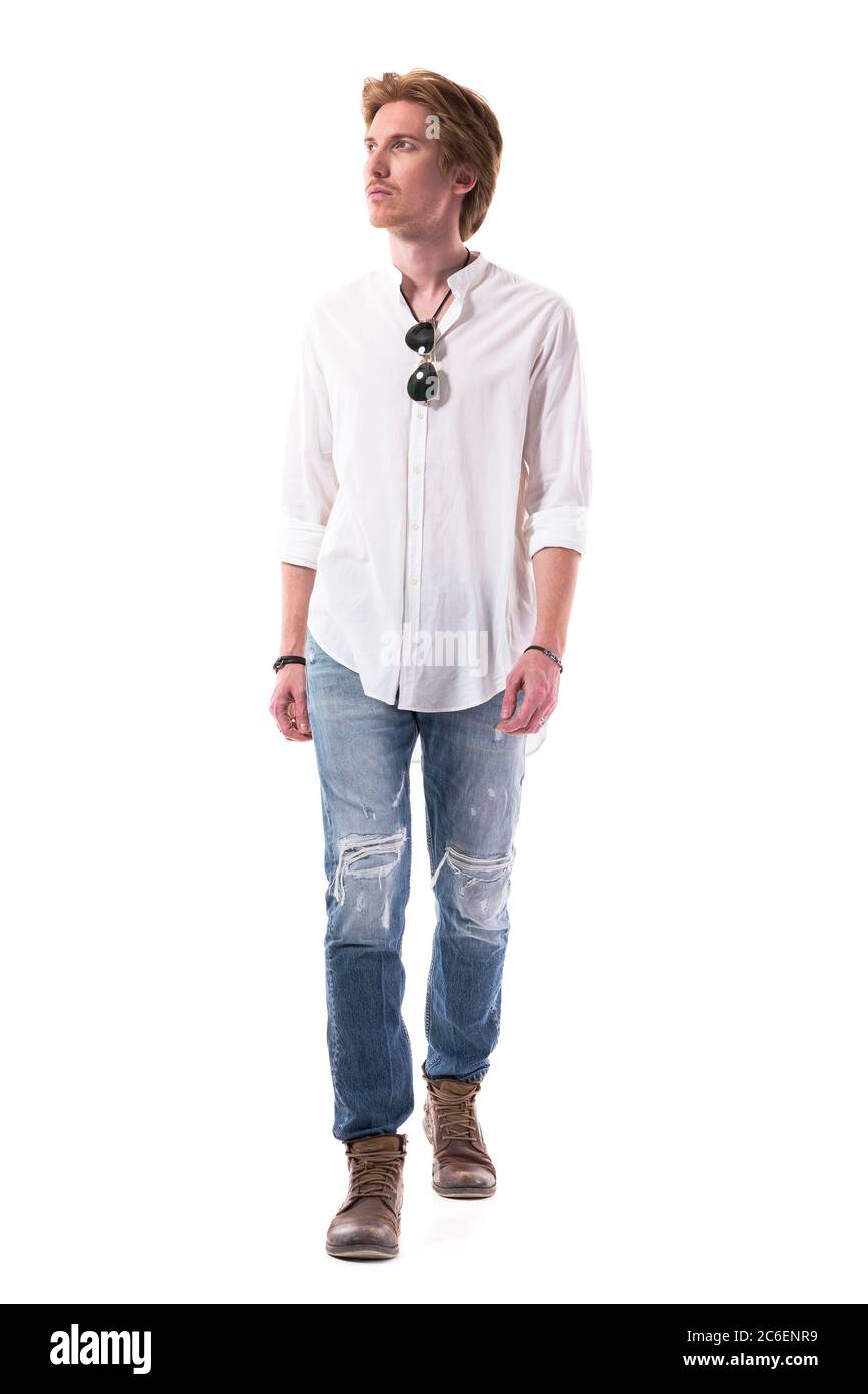 Slim young stylish attractive man fashion model walking in jeans and ...