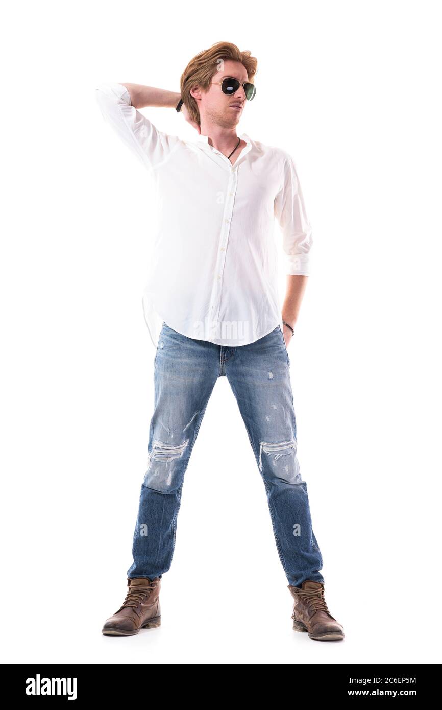 Thoughtful young stylish handsome man looking away scratching head ...