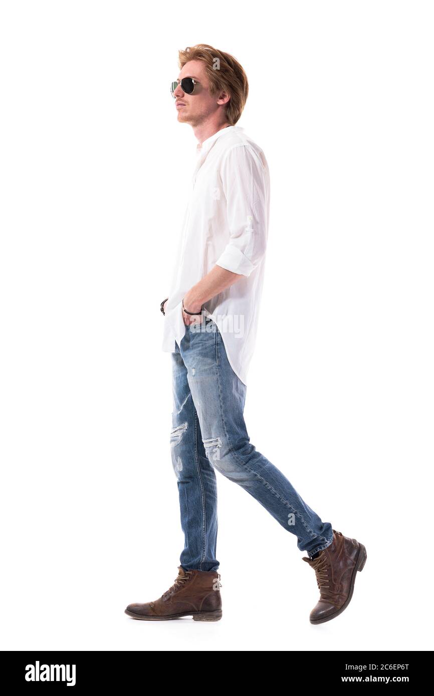 Handsome confident young man with attitude walking and looking ahead ...