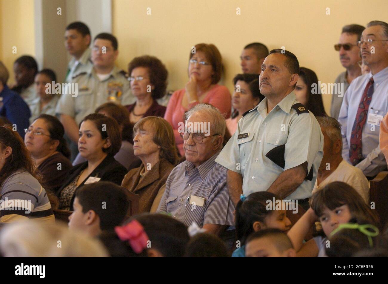 Multi-ethnic crowd listens to presentation in Frio County Courthouse in ...