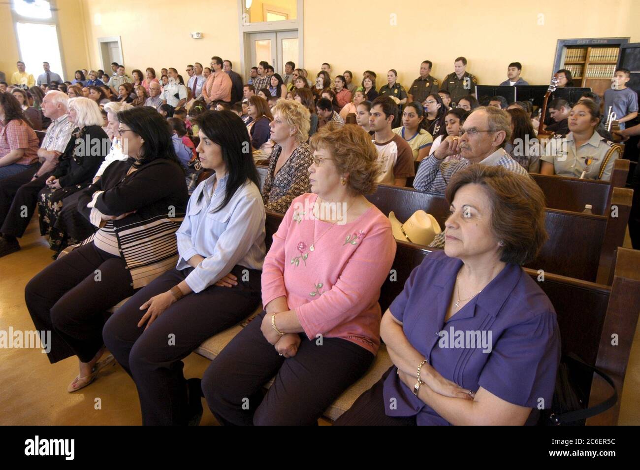 Multi-ethnic crowd listens to presentation in Frio County Courthouse in ...