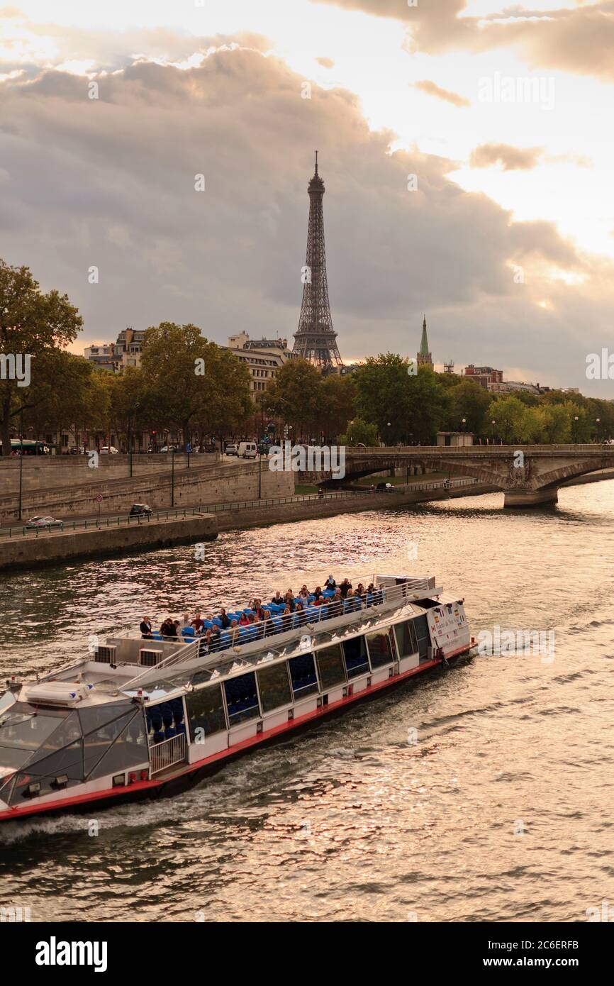 Tour boat on River Seine passing the Eiffel Tower, Paris, France ...