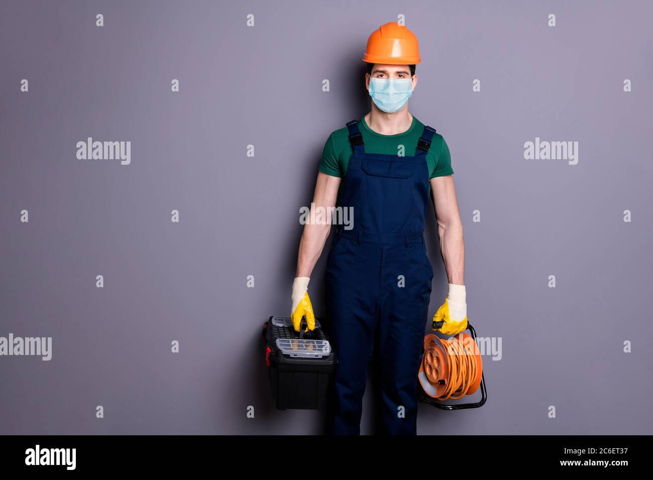 Portrait of his he attractive healthy guy workman wearing safety gauze ...