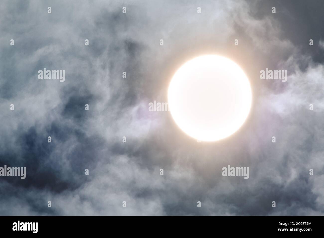 Big bright sun circle in cloudy sky in day time. Sun in white fluffy ...