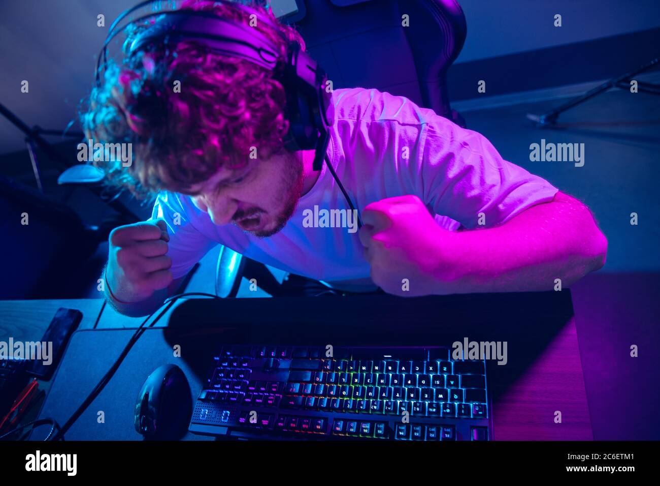 Cyber sport. Fully concentrated professional cybersport gamer playing ...