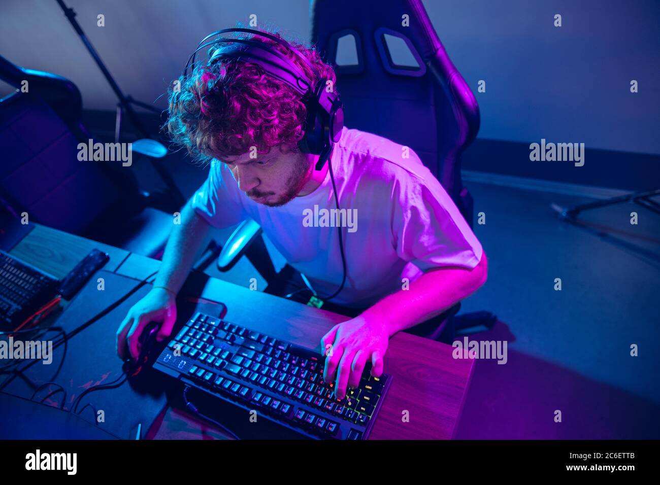 Cyber sport. Fully concentrated professional cybersport gamer playing ...