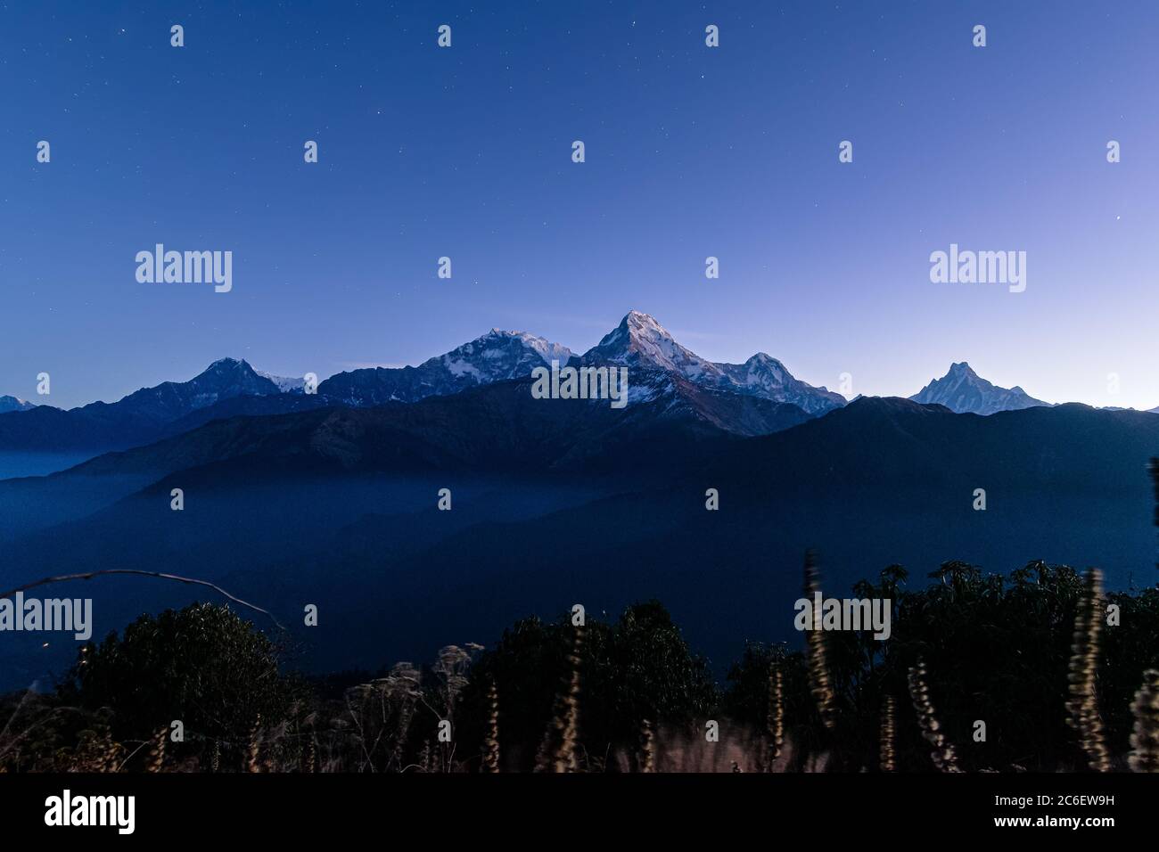 Early dawn and sunrise over the Machapuchare Annapurna mountain range ...