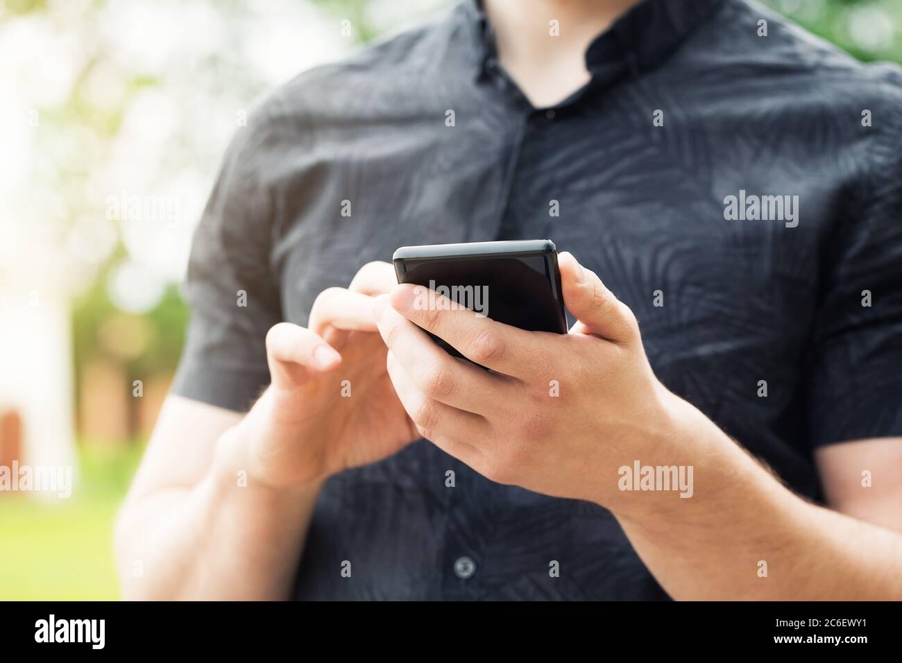 Man using mobile smart phone, close up. Young man holding mobile smart ...