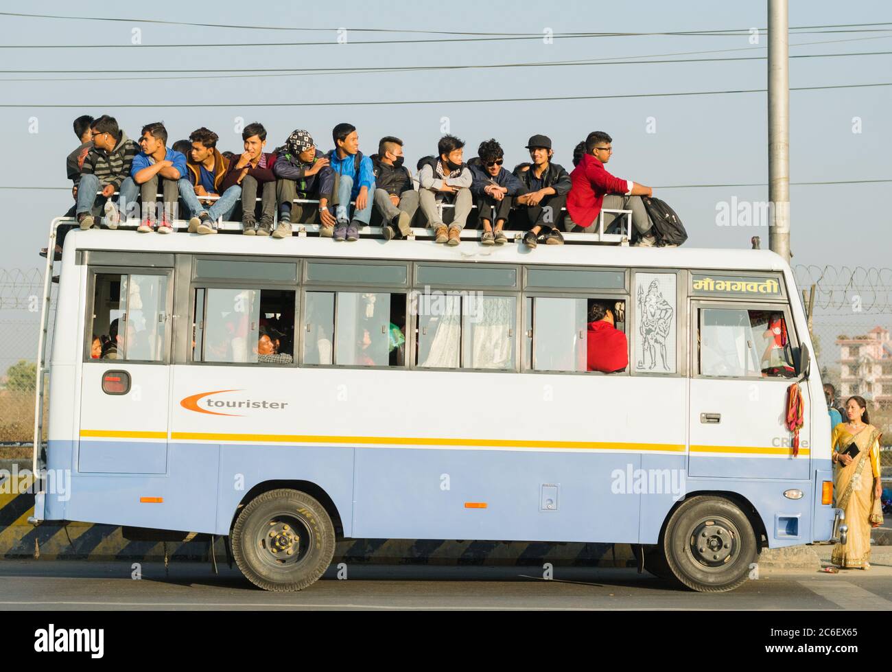 Kathmandu, Nepal - 22 Nov 2015: Commuters pack into and on top of the ...