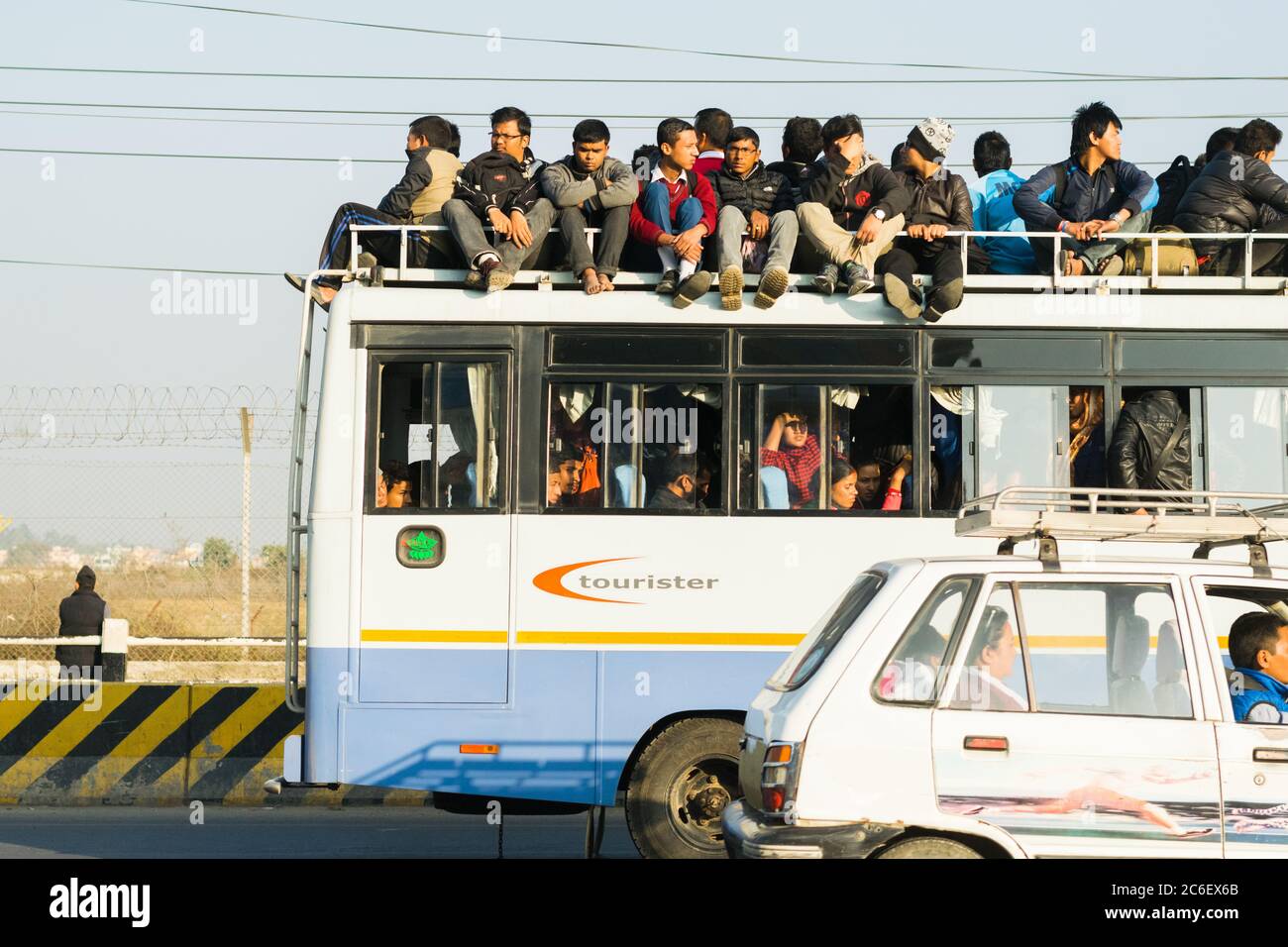 Kathmandu, Nepal - 22 Nov 2015: Commuters pack into and on top of the ...