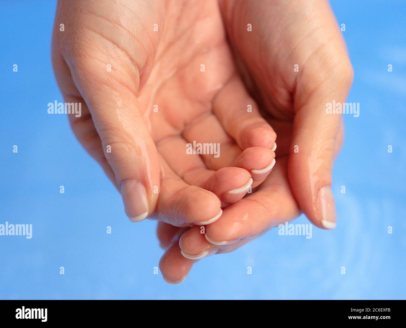 Washing hands in water, macro, blue background Stock Photo - Alamy