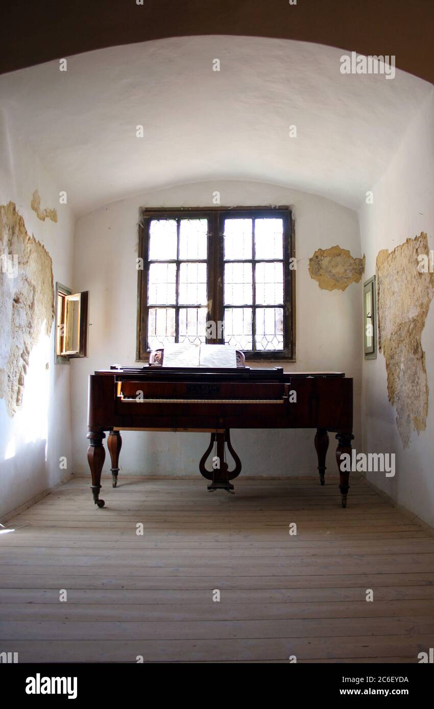 Old empty medieval room with piano Stock Photo - Alamy