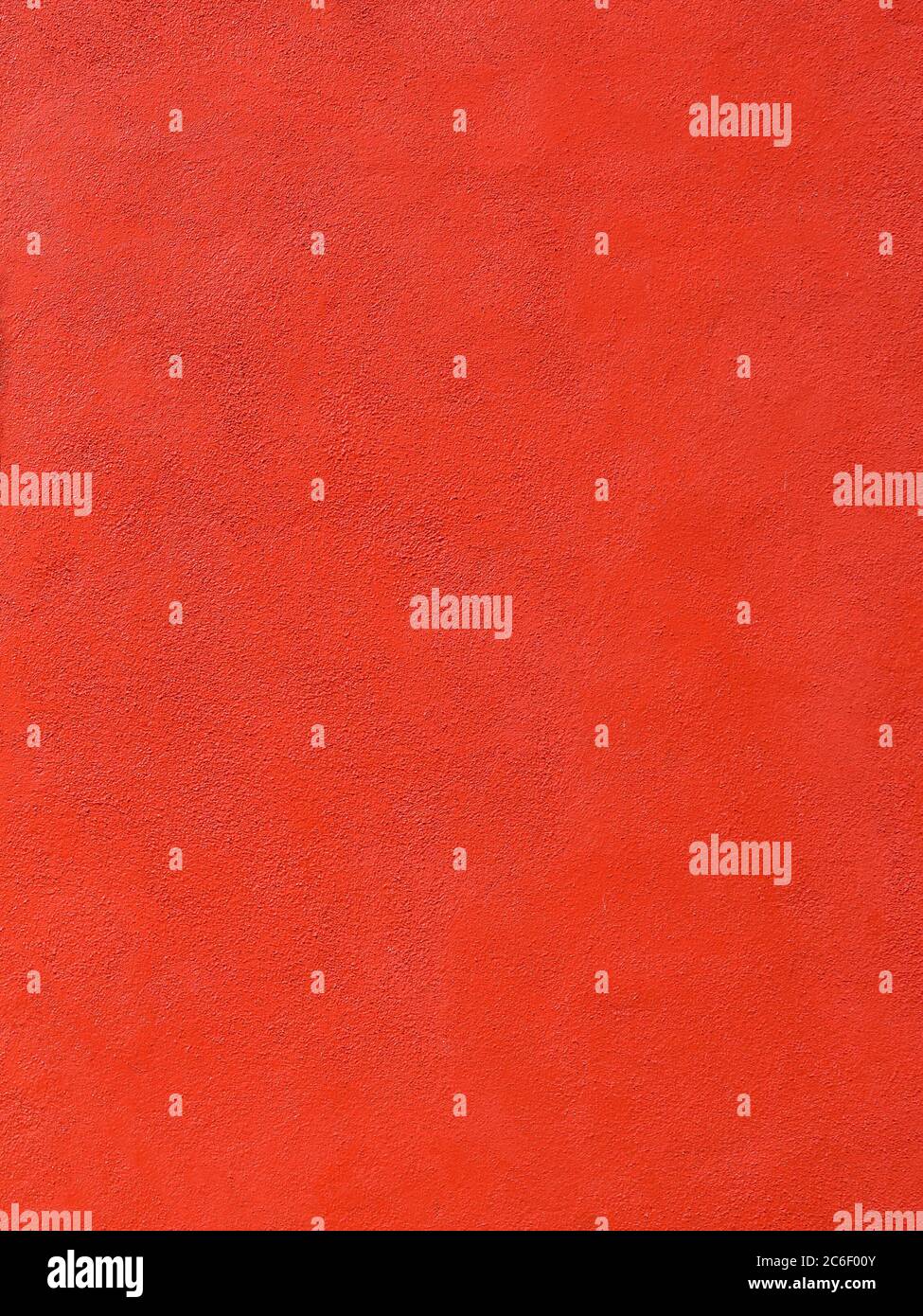 Natural background. Red color plaster on a stone wall Stock Photo - Alamy