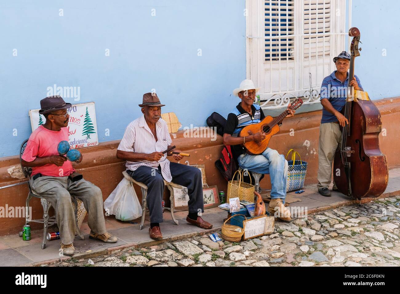 A group of Cuban musicians play on the side of the street in Trinidad ...