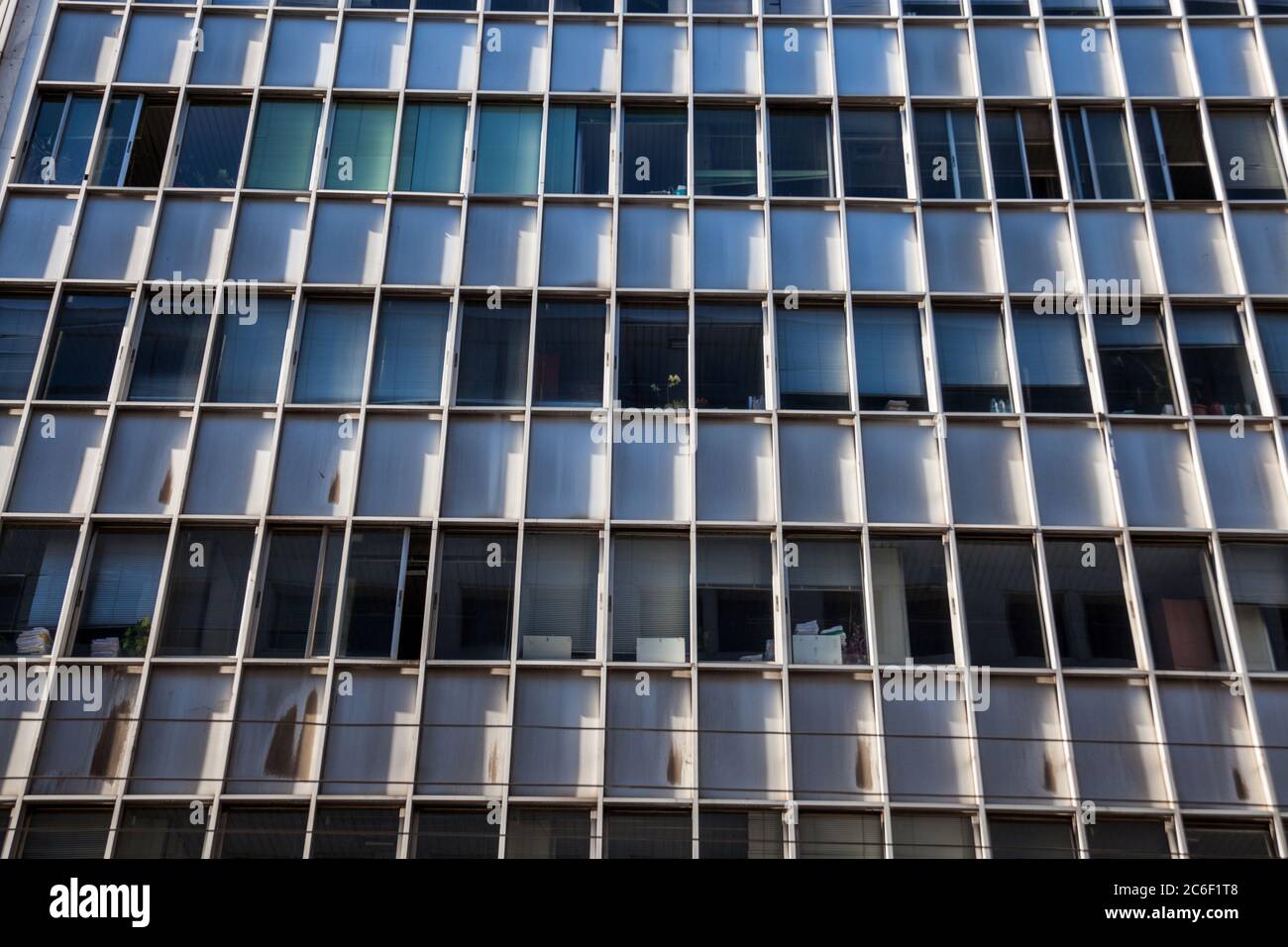Weathered windows modern city office building Stock Photo - Alamy