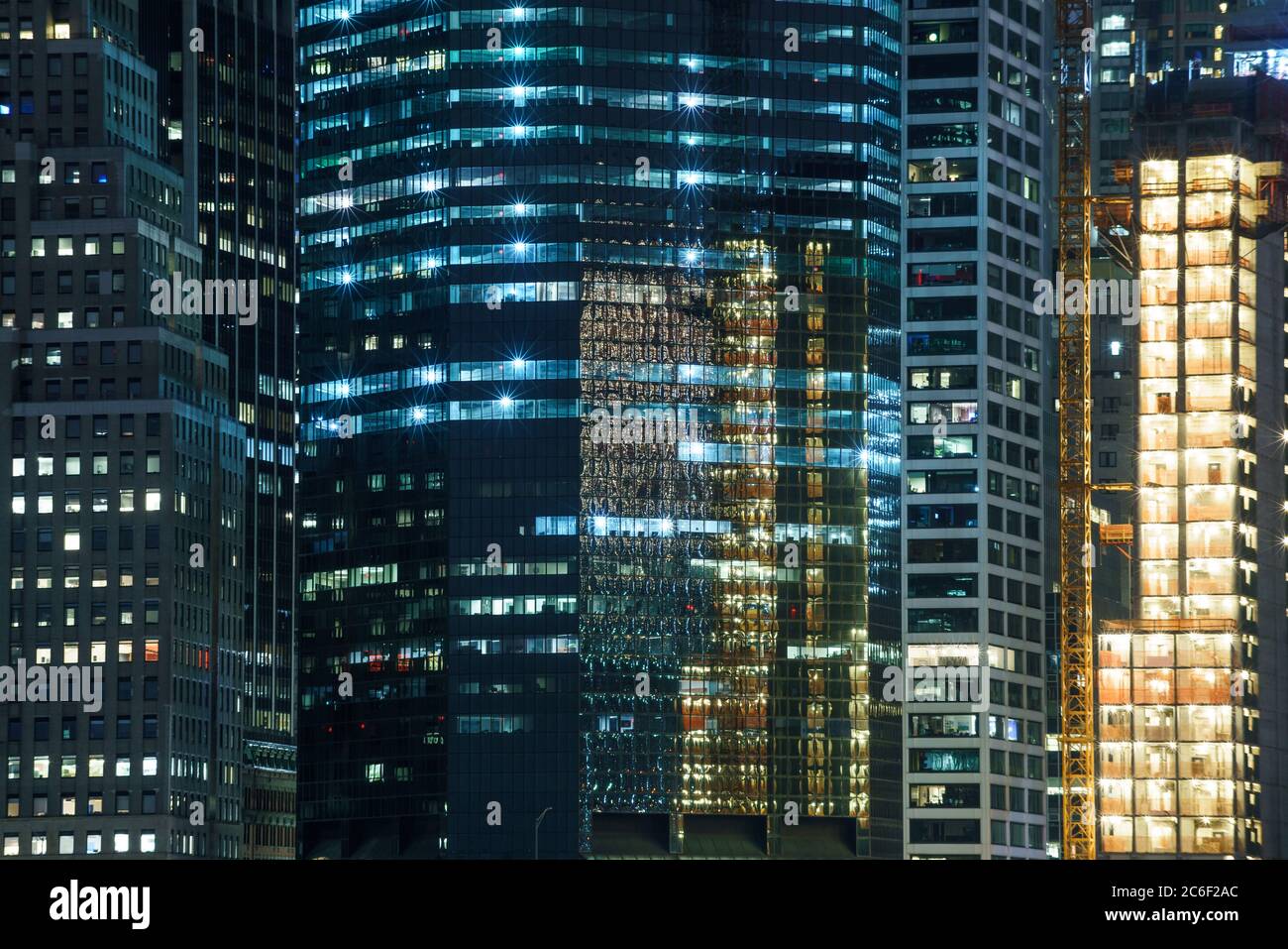 Windows of Manhattan buildings illuminated by artificial light at night ...